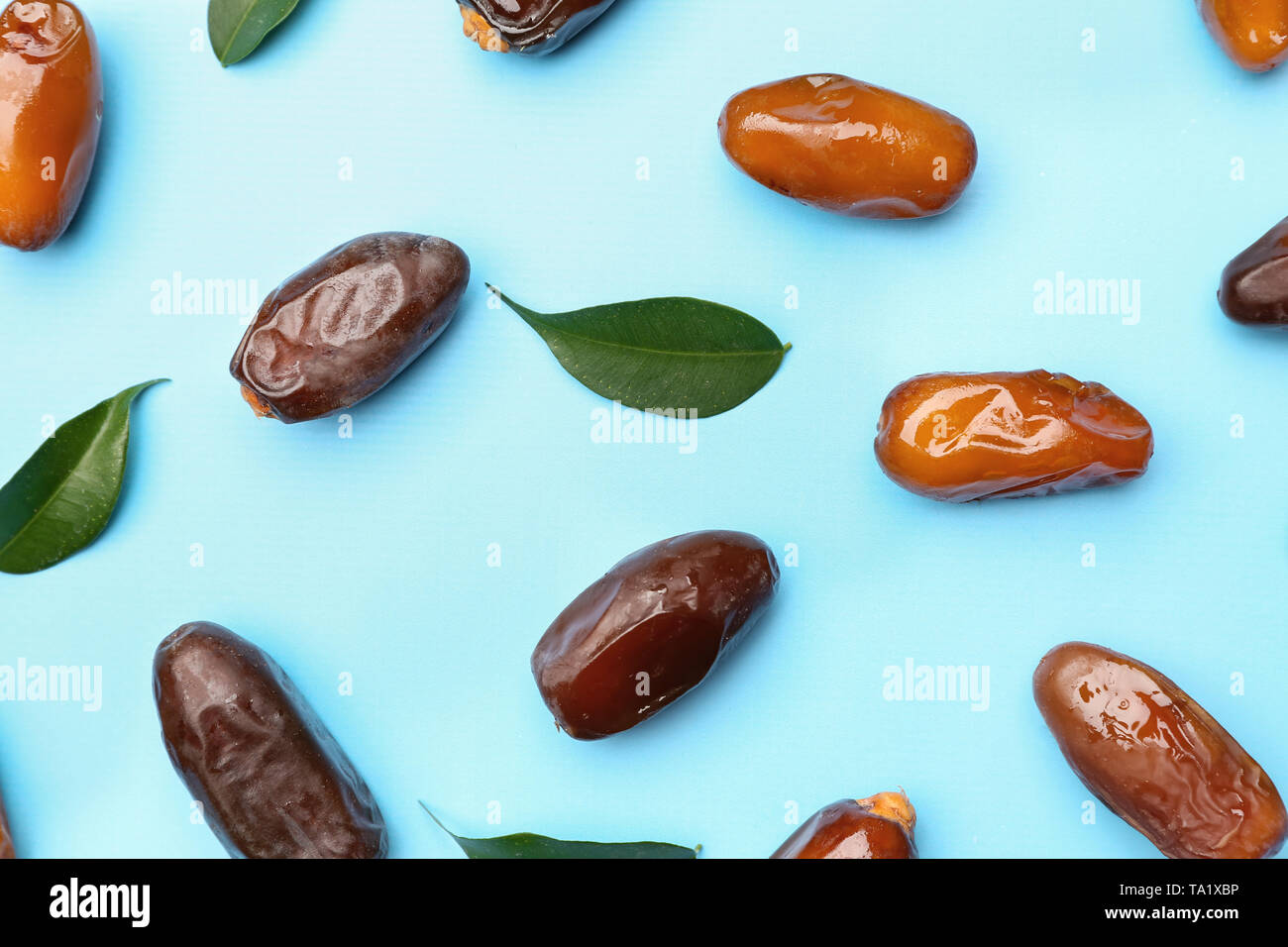 Sweet dried dates on color background Stock Photo - Alamy