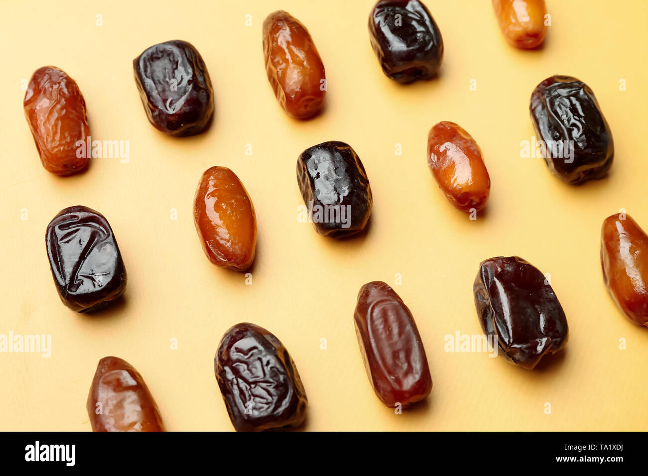 Sweet dried dates on color background Stock Photo - Alamy