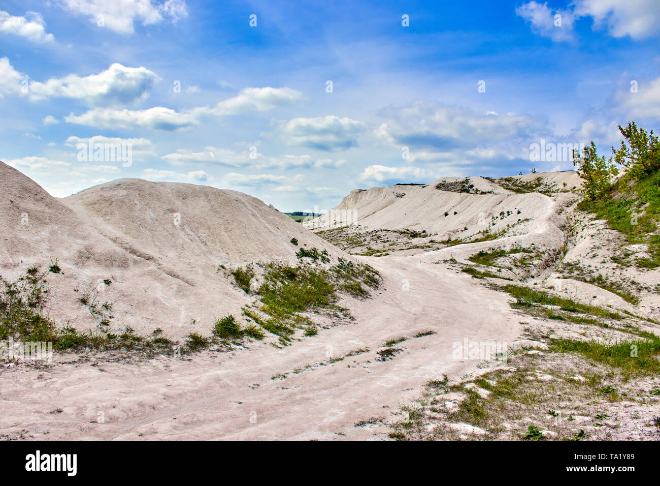 white limestone quarry on a background of blue sky with clouds Stock ...