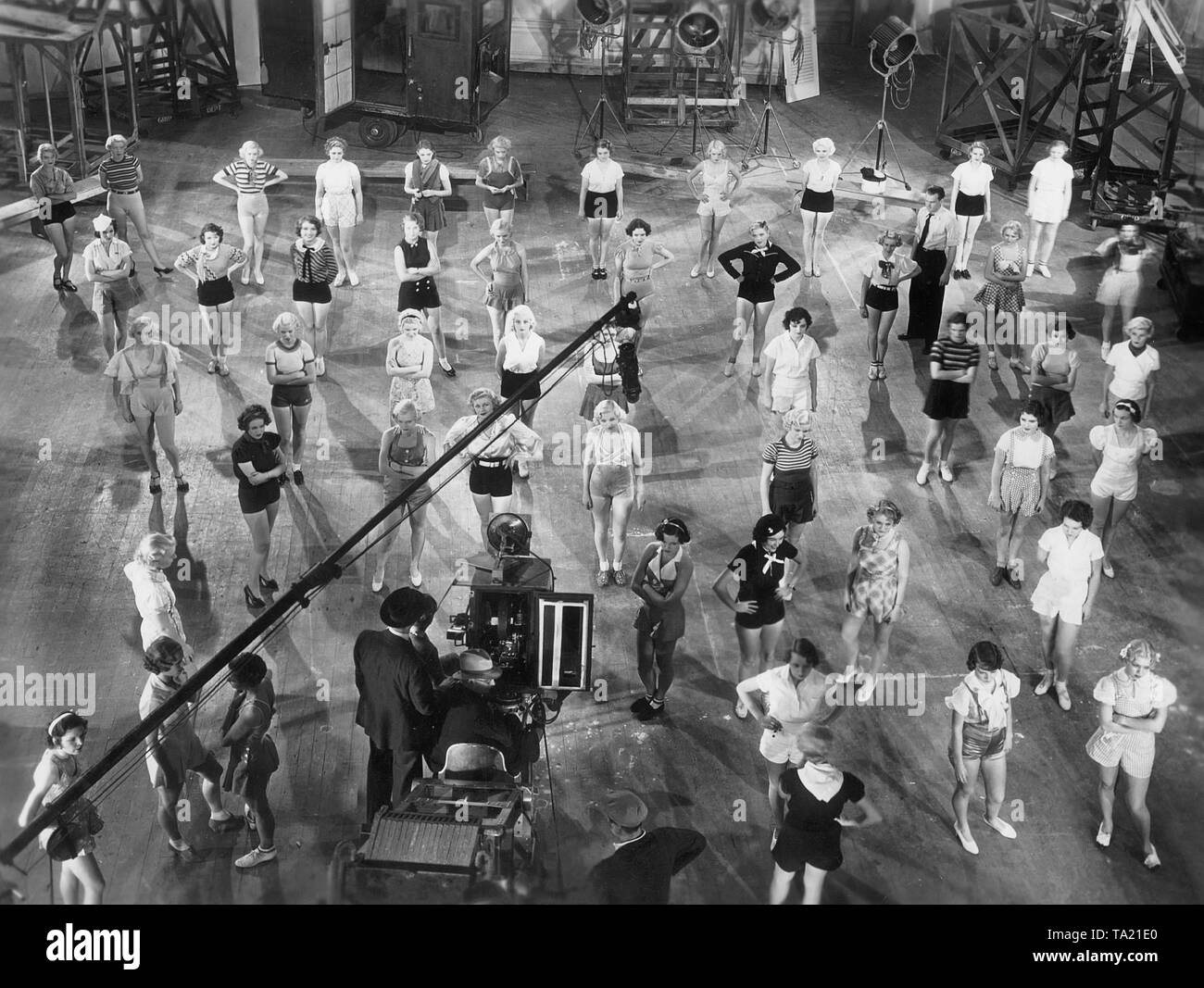 The cameraman and showgirls filming a big dance scene in the movie "The ...