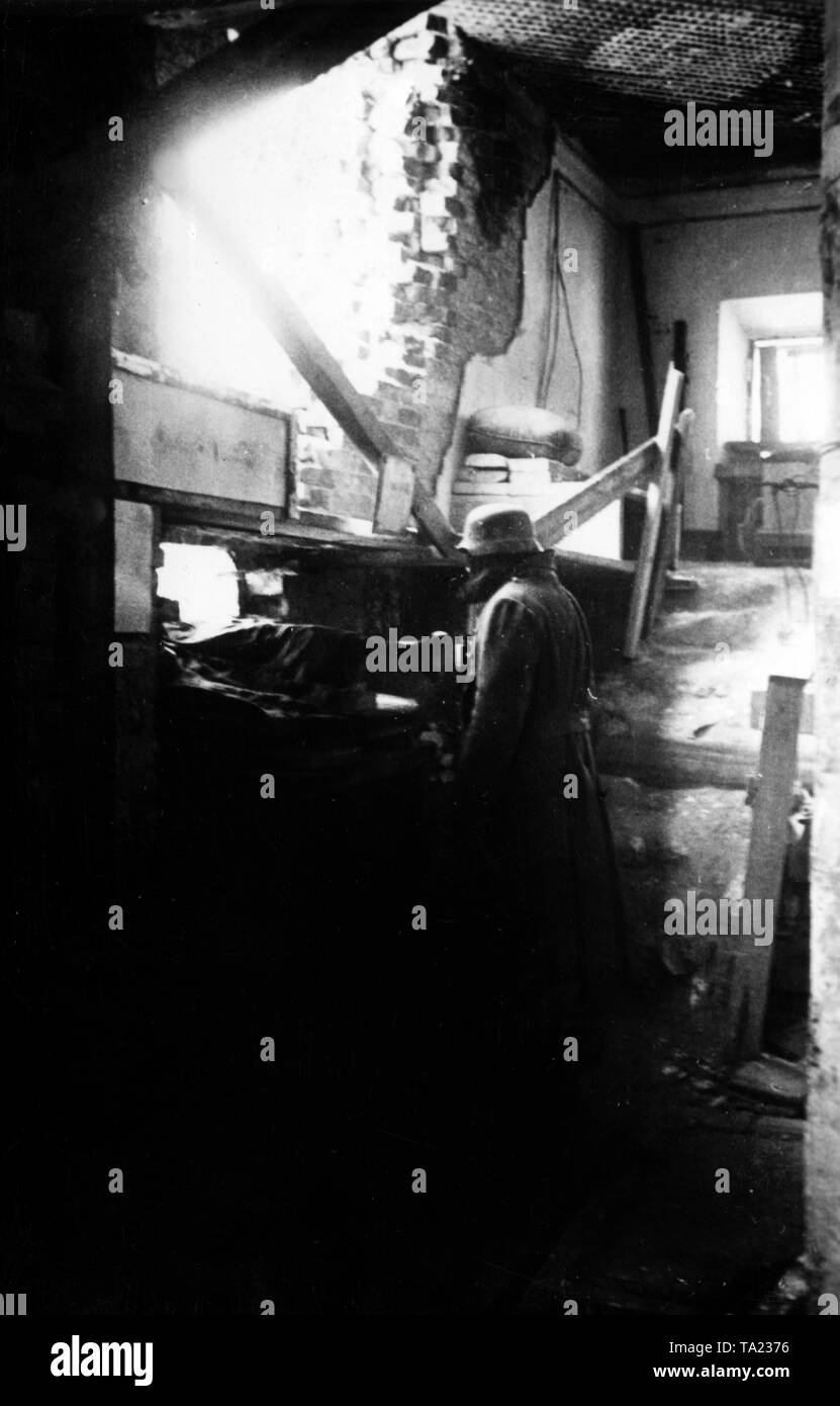 A German soldier has entrenched himself with a machine gun in an old ...