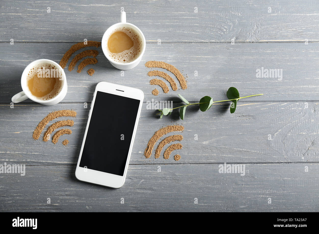 Composition with cups of coffee, mobile phone and wifi symbols on ...