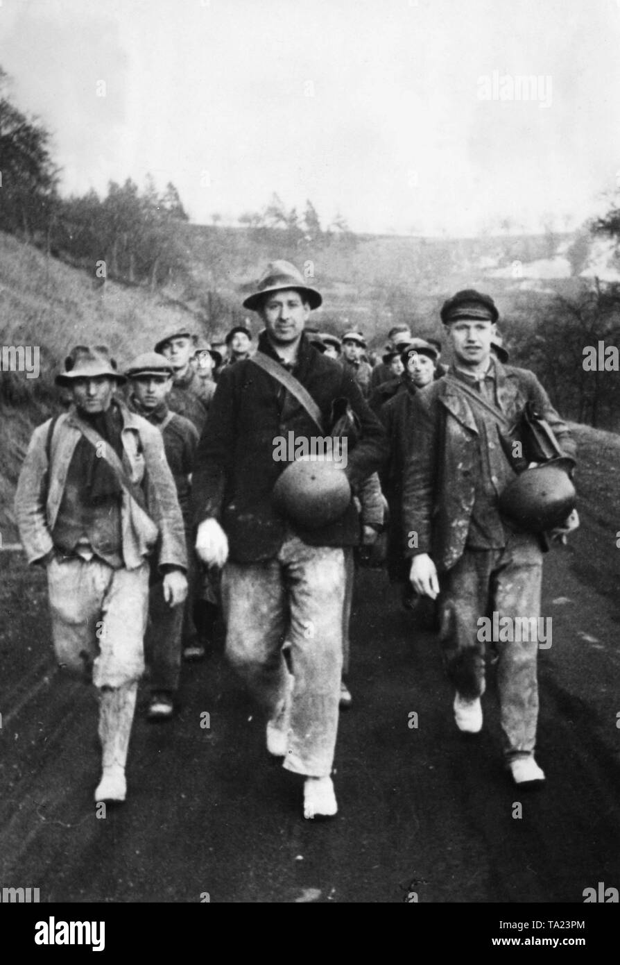 Workers of the Todt Organization march back to their camp in line after ...