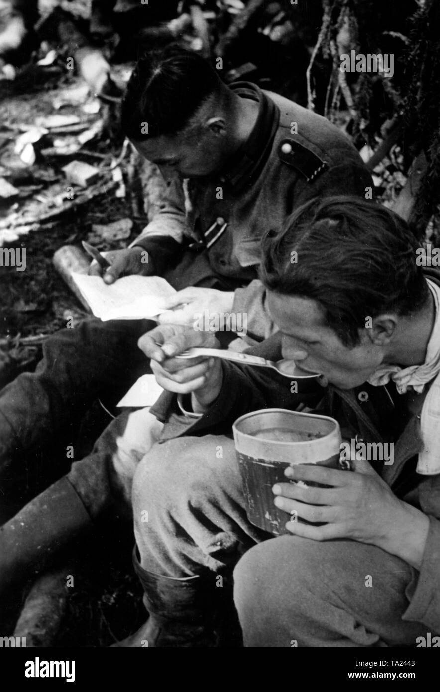 German soldiers take a break to read their field post and eat. Photo of ...