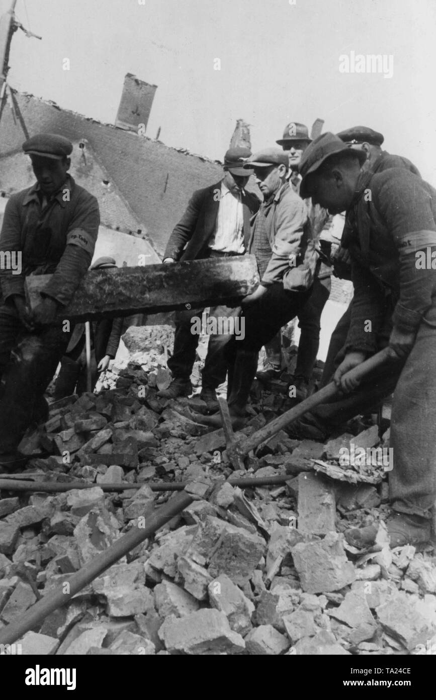 Men of the Todt Organization at clearing work, equipped with pickaxes ...