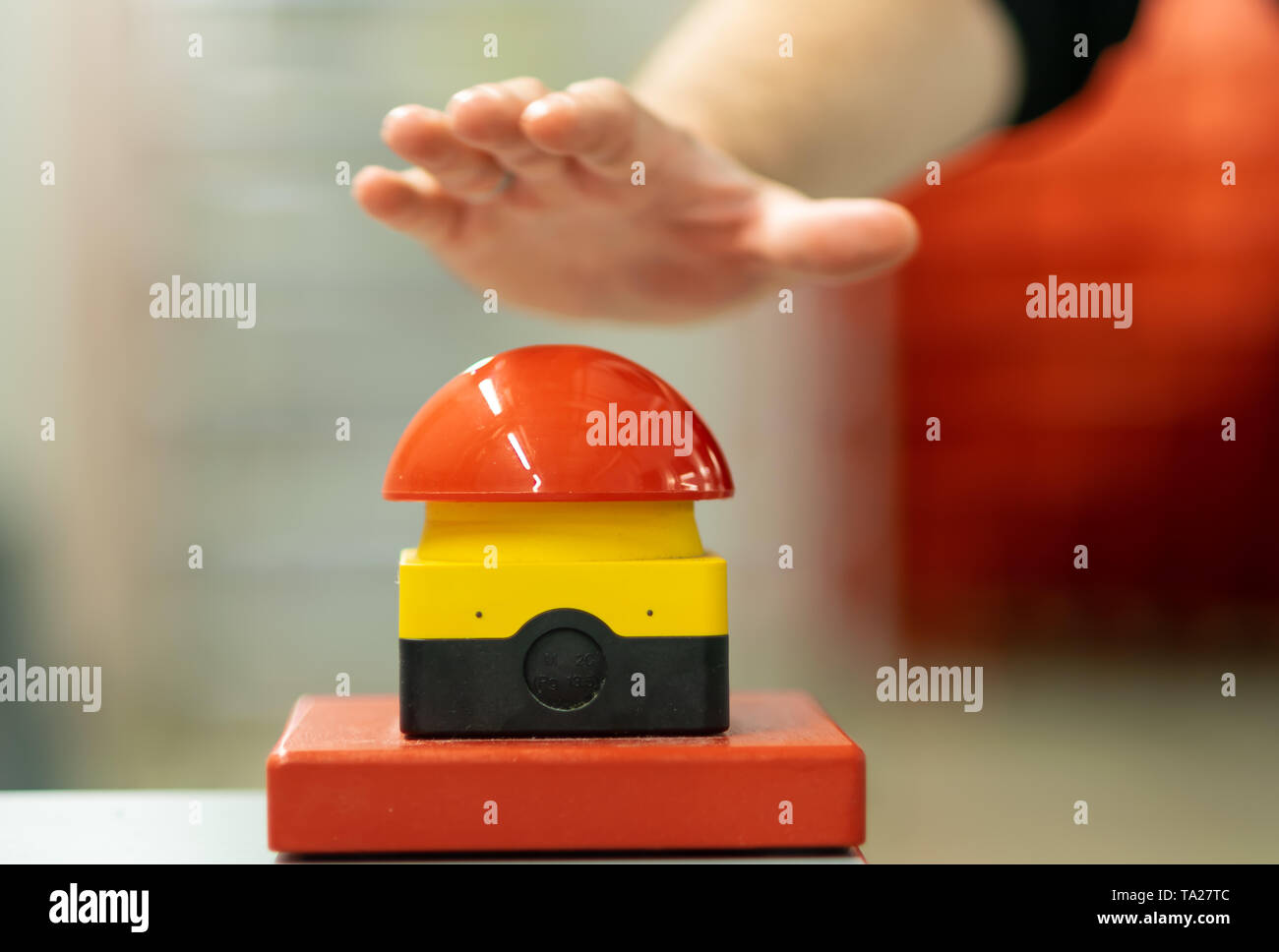 Worker has to press the emergency button fast Stock Photo - Alamy