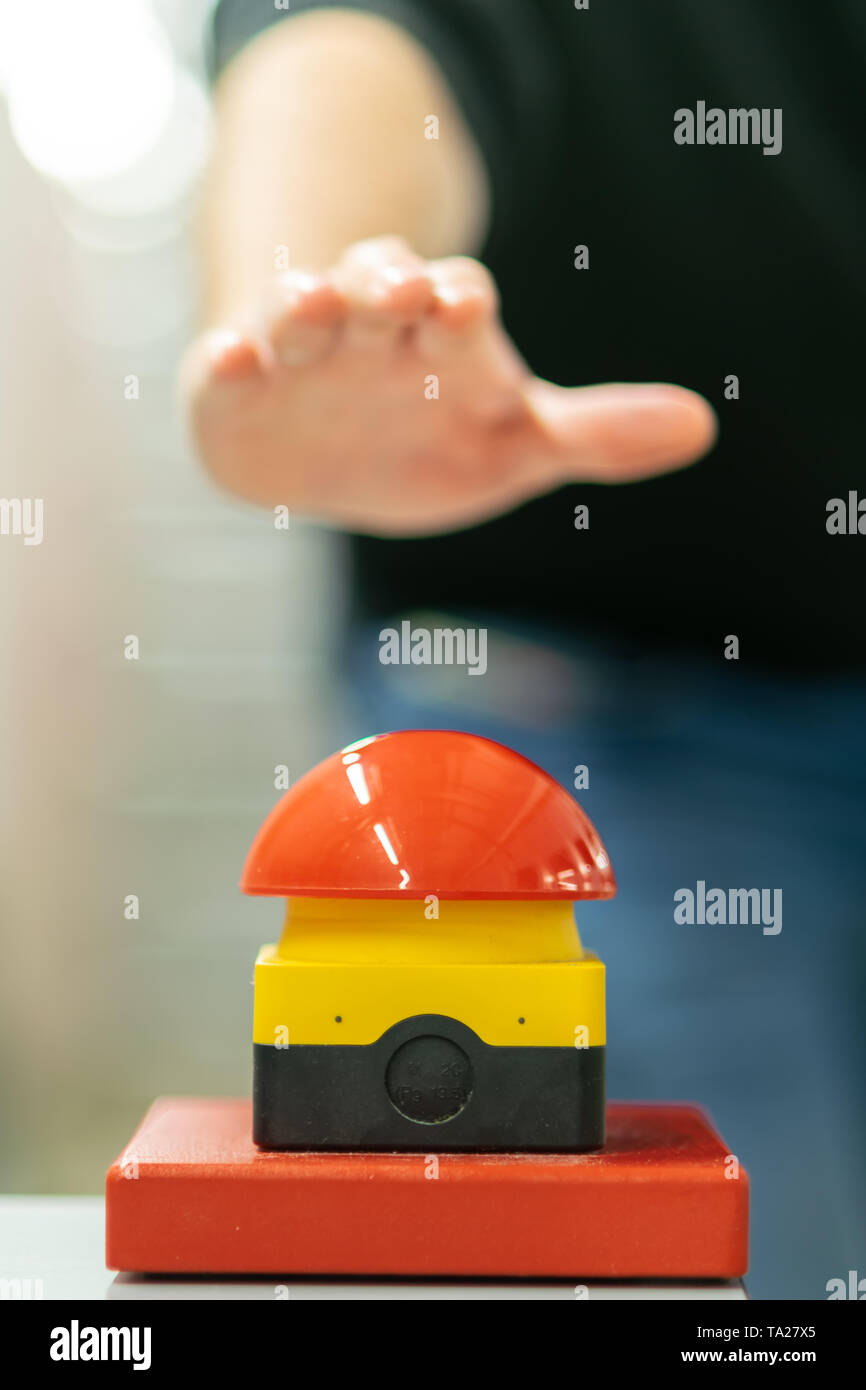 Worker has to press the emergency button fast Stock Photo - Alamy
