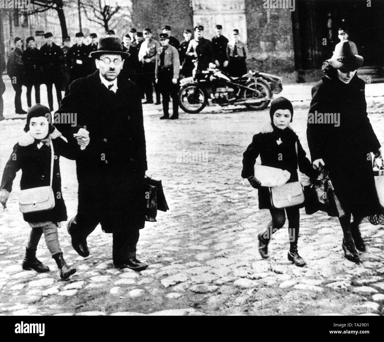 A Jewish family in Memel walk to the station packed with a few ...