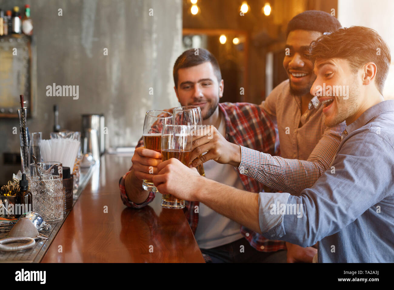 Male friends talking and drinking beer hi-res stock photography and ...