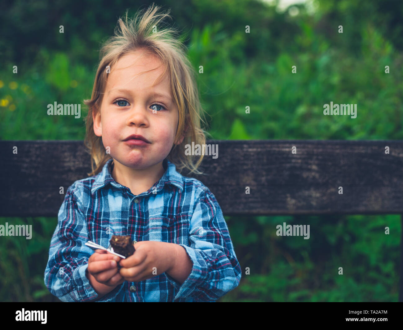 Child eating bar of chocolate hi-res stock photography and images - Alamy