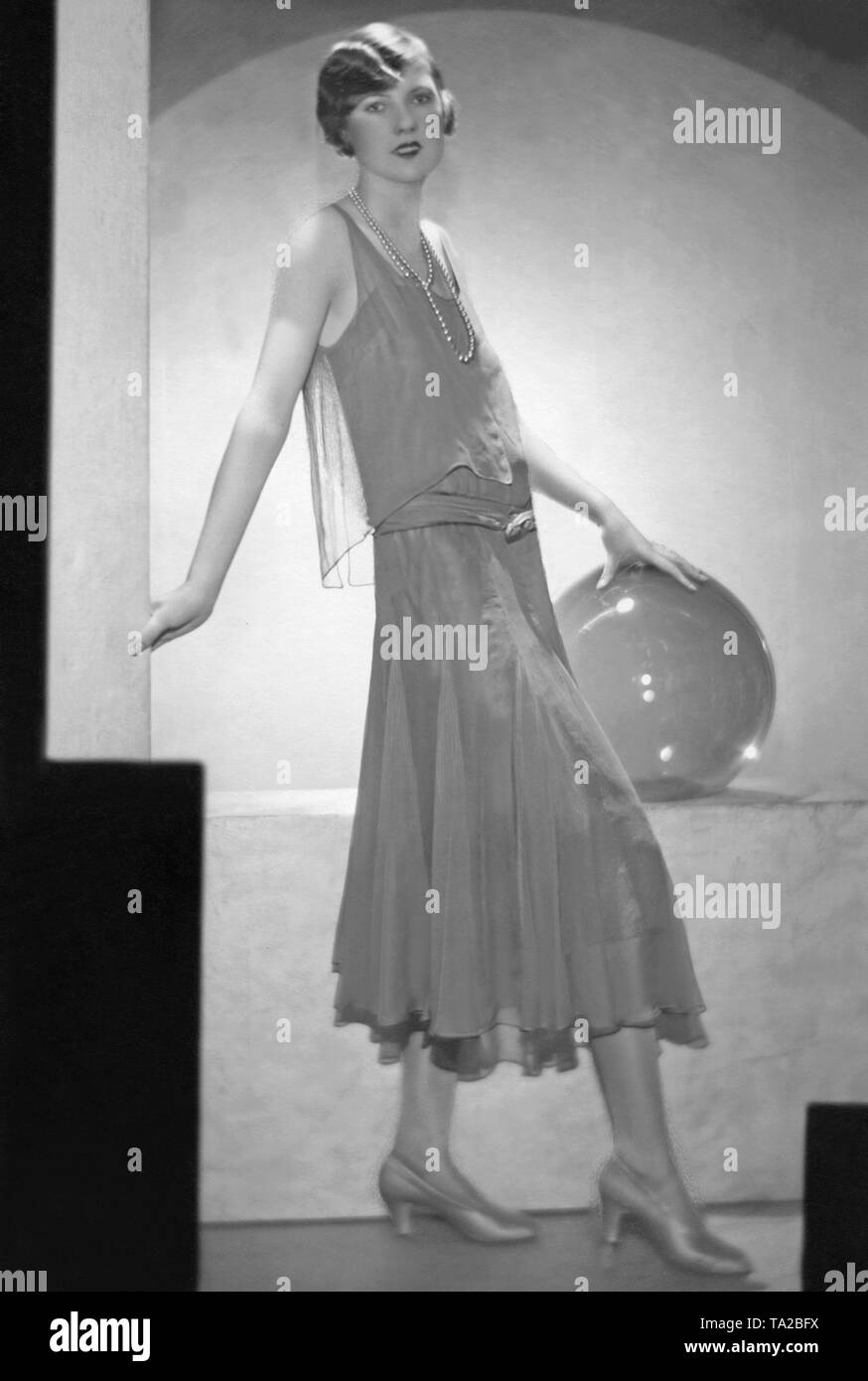 A model presents a dance dress made of blue voile and sleeveless little ...