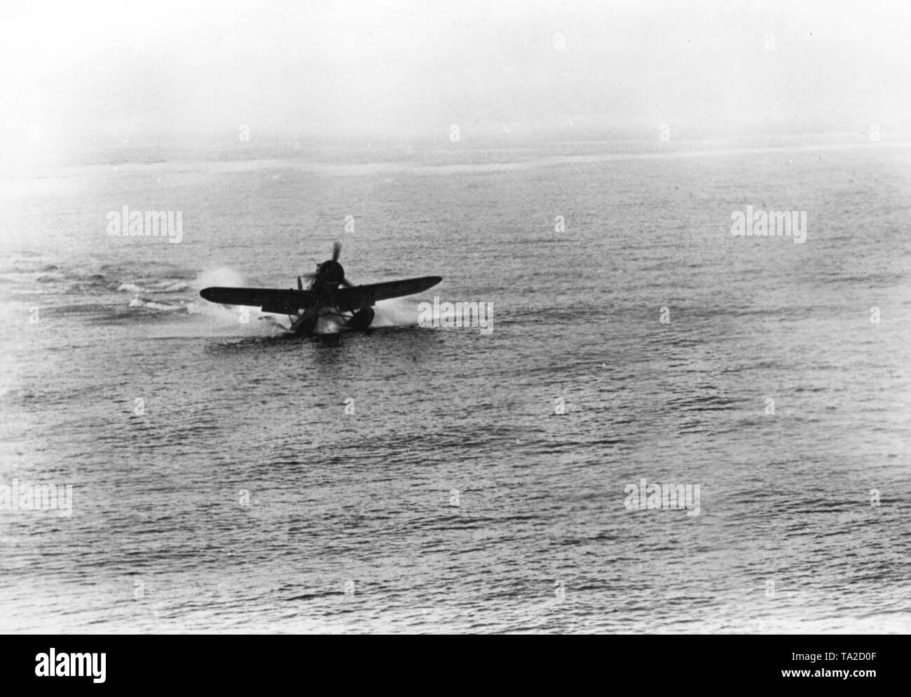 During a mission an Arado Ar 196 seaplane lands near a battleship of ...
