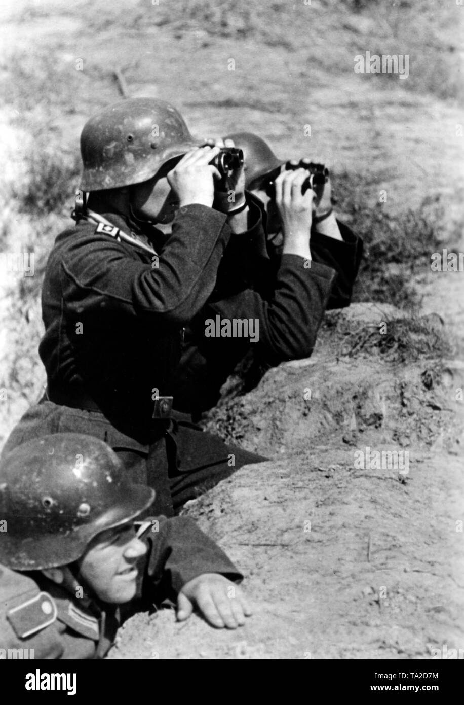 German soldiers watch the enemy positions out of a ditch. Photo of the ...
