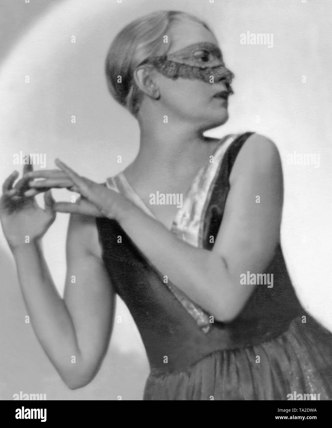 Disguised woman, probably a dancer. She is wearing a mask on her face ...