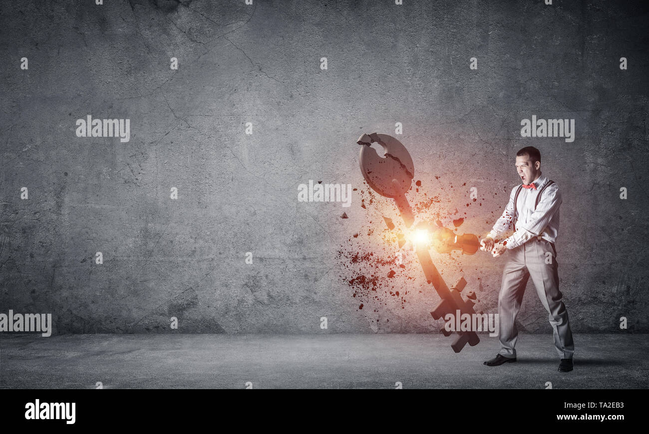 Breaking through access concept with man in room crashing concrete key ...