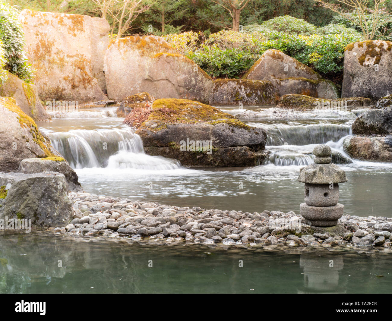 Long exposure image of running river in bautiful japanese garden setup ...