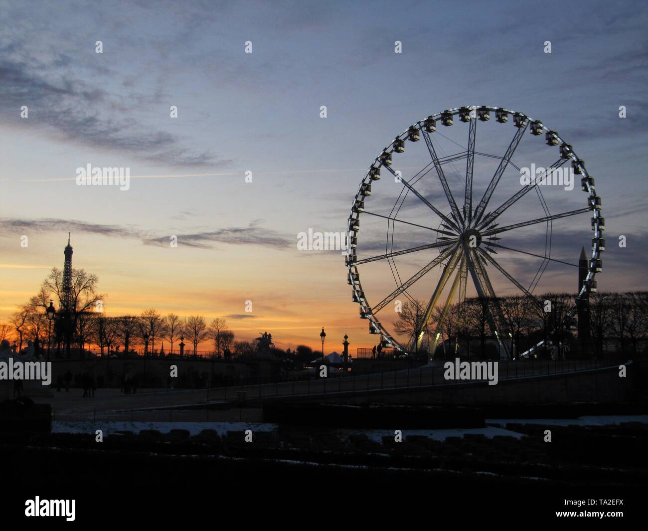 A Ferris wheel in a park during sunset Stock Photo - Alamy
