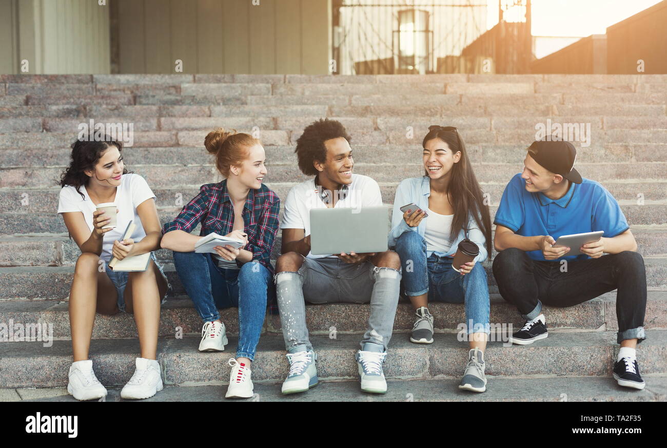 Group friends sitting on stairs hi-res stock photography and images - Alamy