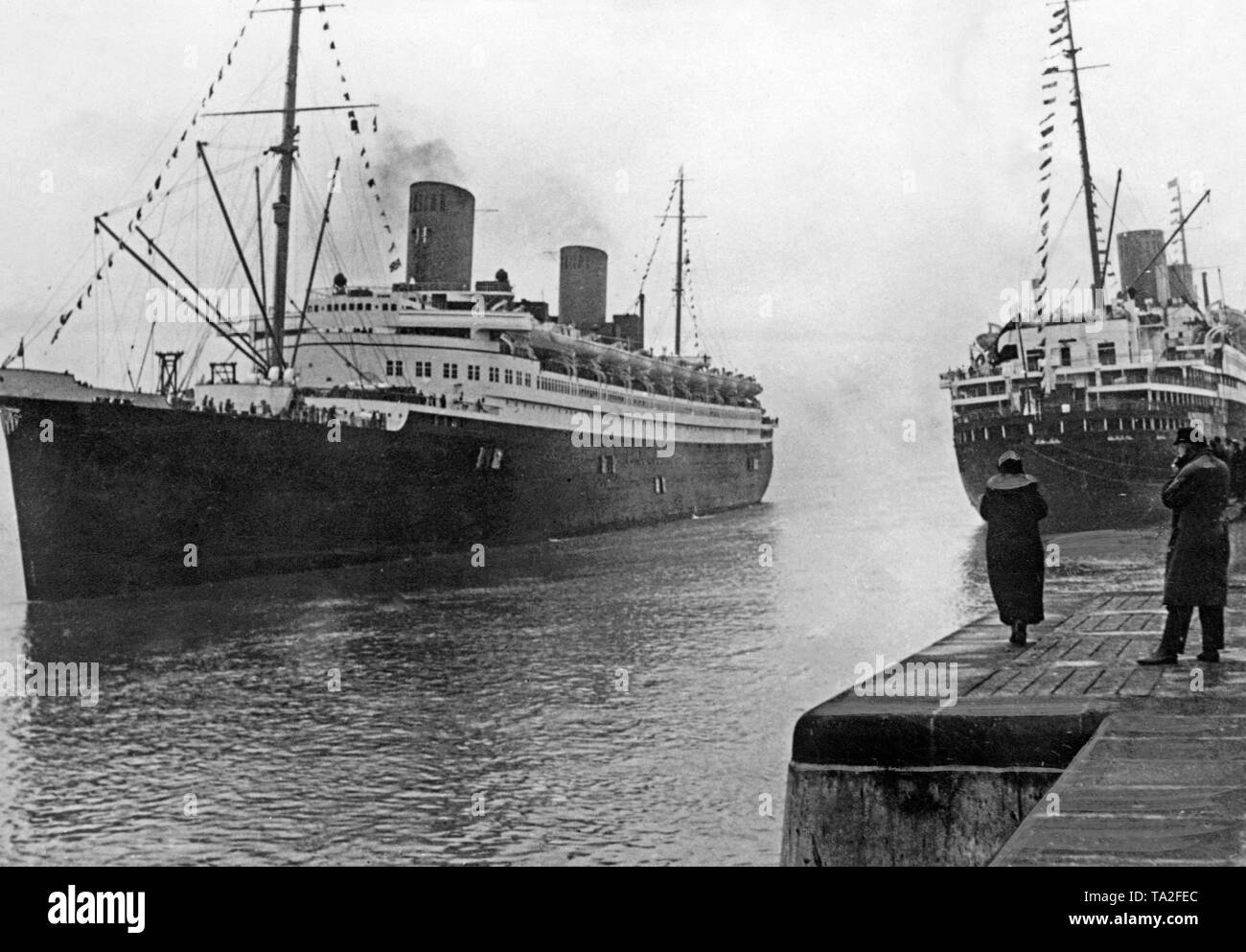 The fast steamer "Bremen" (left) reaches her homeport Bremerhaven after ...