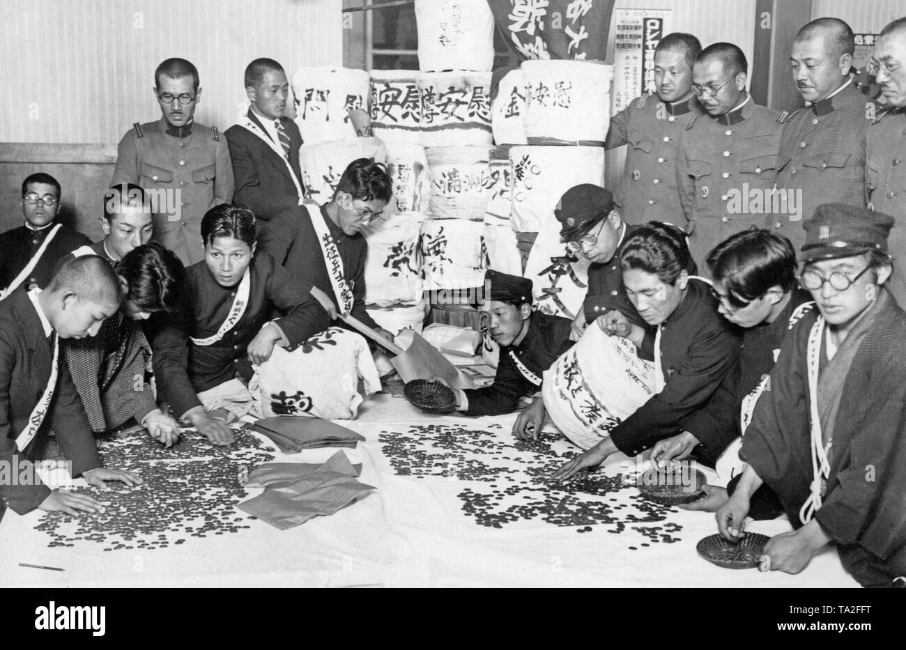 A group of students counting change, which they have collected as ...