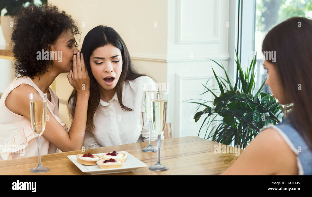 Gossip secret talking friendship hi-res stock photography and images ...