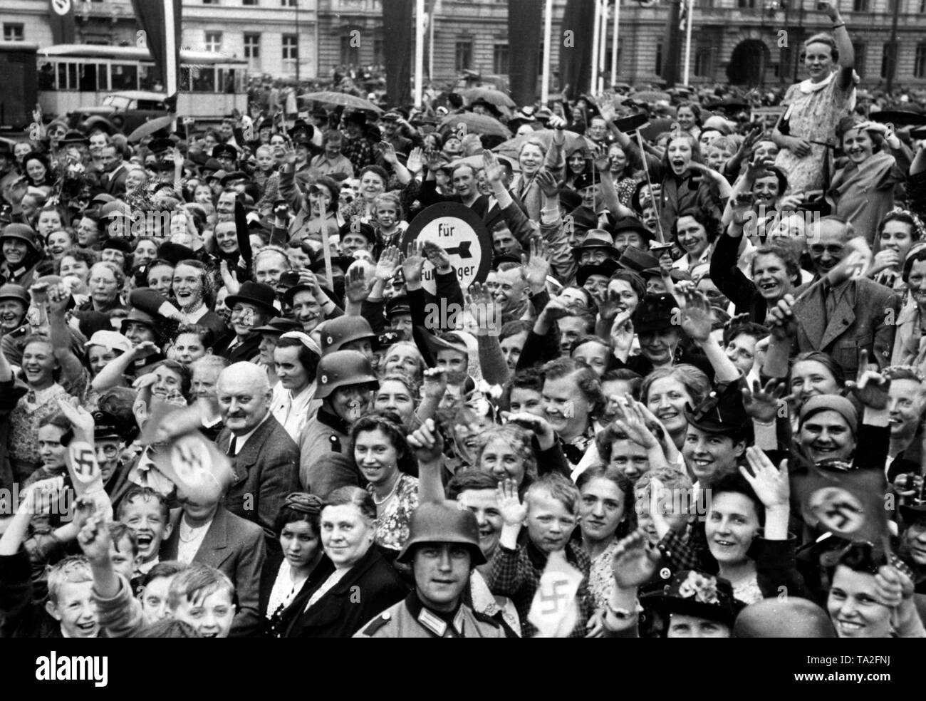 People cheer during the parade of German troops after the end of the ...