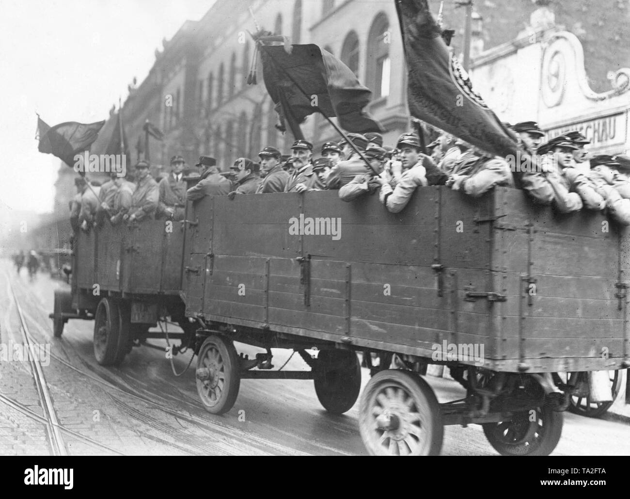 Uniformed members of the Reichsbanner ride in a car with trailers to ...