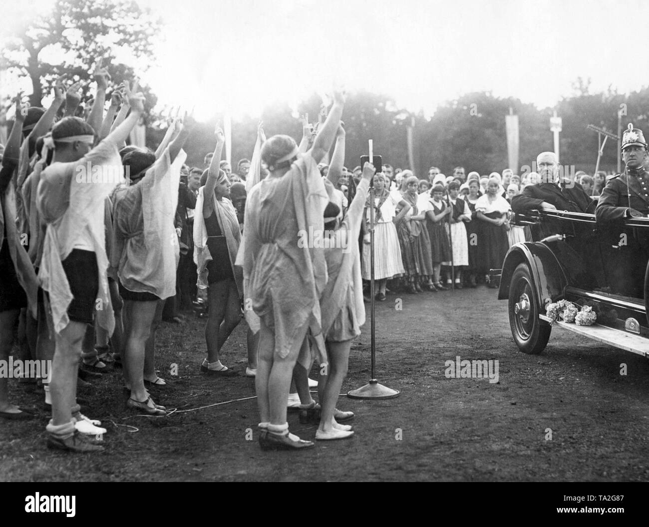 Some youths show their oath of allegiance with a hand sign during a ...
