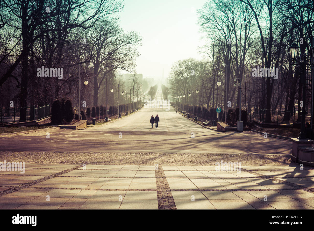 very long and straight path through a park with people walking Stock ...