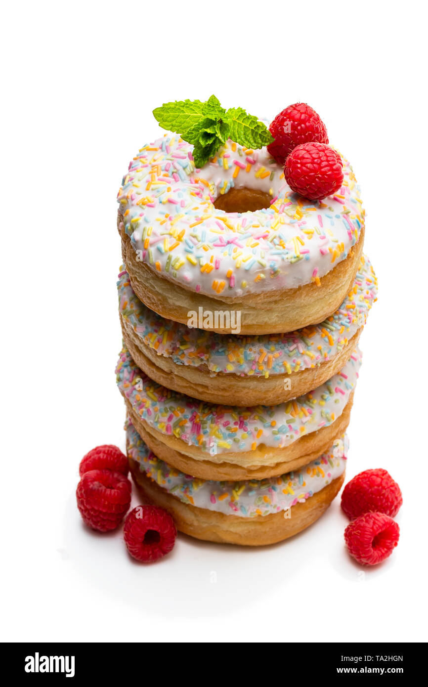 Pink doughnuts with sprinkles and fresh raspberry isolated on white ...