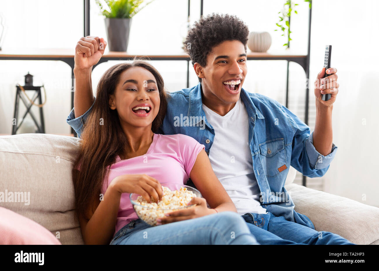 Happy teen watching tv hi-res stock photography and images - Alamy