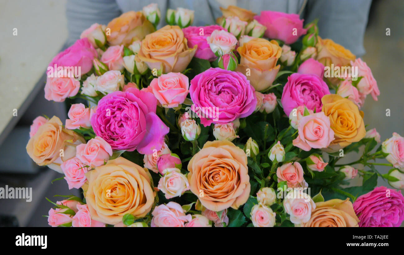 Professional florist showing bouquet at studio Stock Photo - Alamy