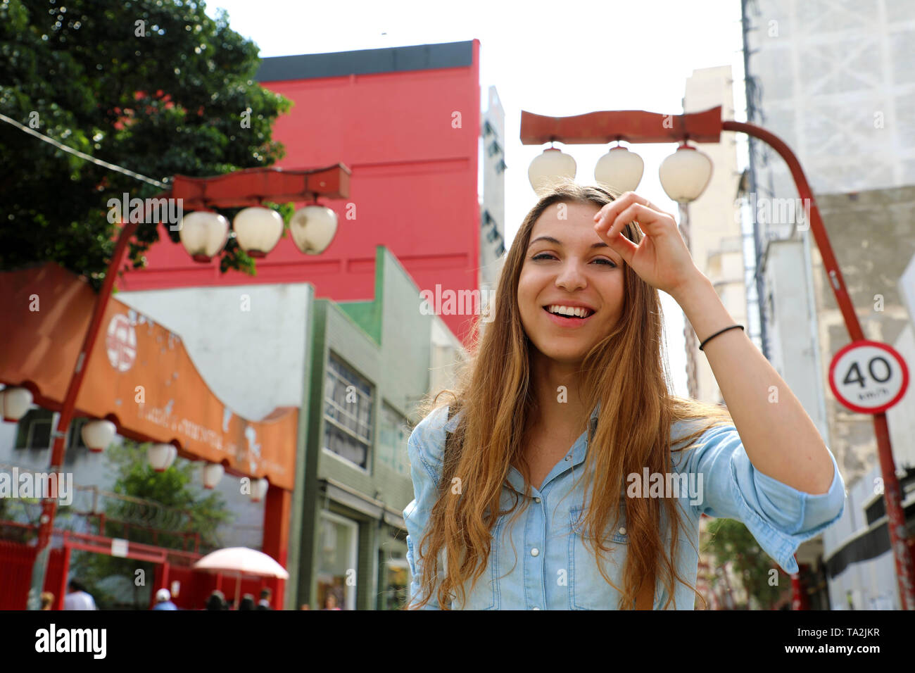Beautiful smiling girl walking in Sao Paulo japanese neighborhood ...