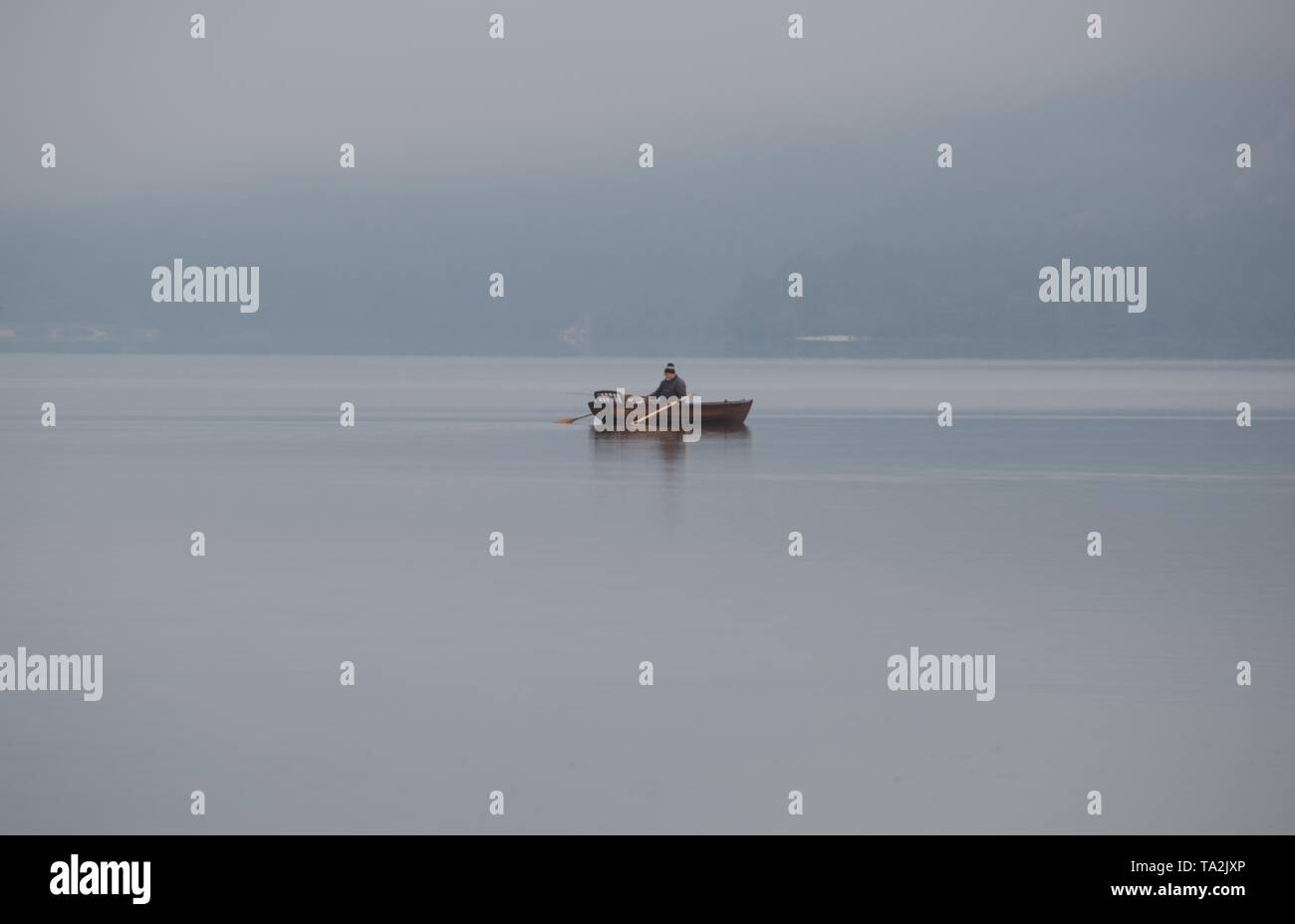 Man alone in row boat hi-res stock photography and images - Alamy