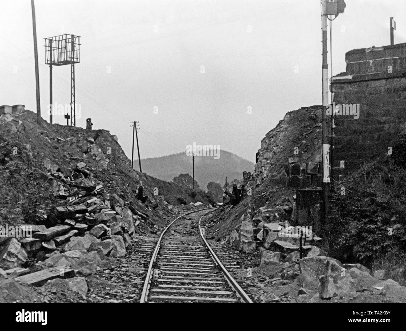 View of a railroad track that was driven across a hill. On the left and ...