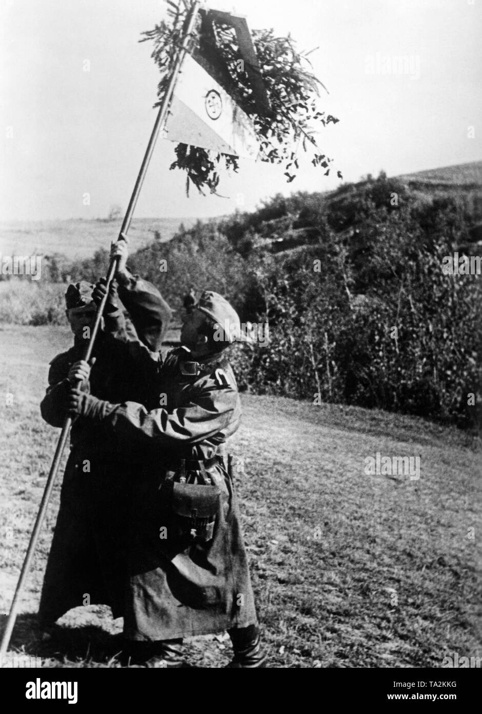 German soldiers at the divisional command post set up the pennant of a ...