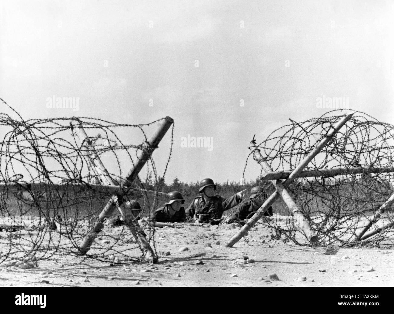 German infantrymen take shelter behind a barbed wire obstacle Stock ...