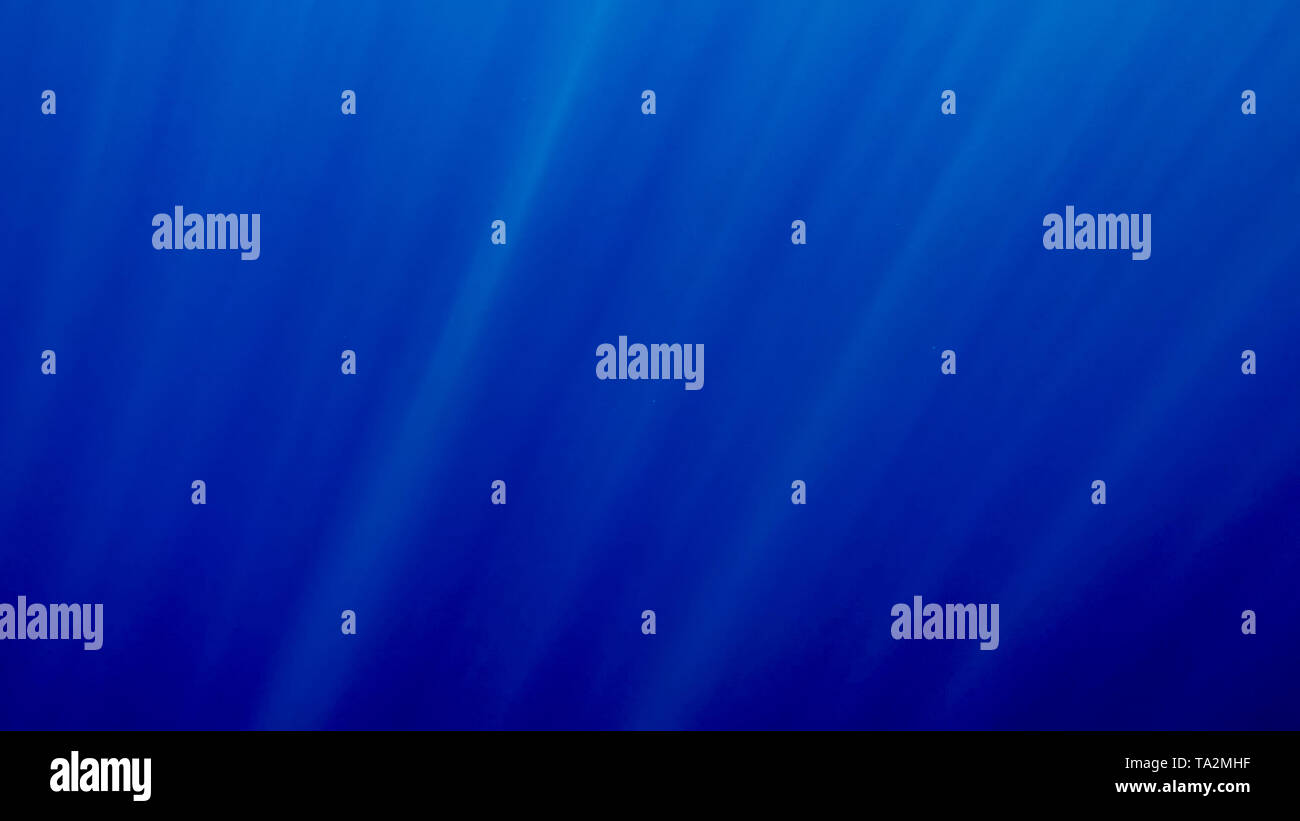 Beautiful photo of sun rays shining through deep sea surface Stock ...