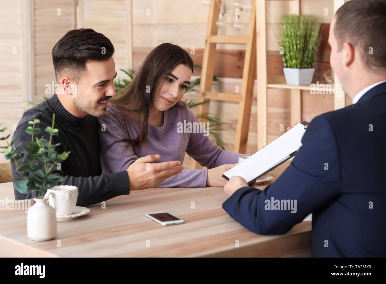 Young couple meeting with insurance agent in cafe Stock Photo - Alamy