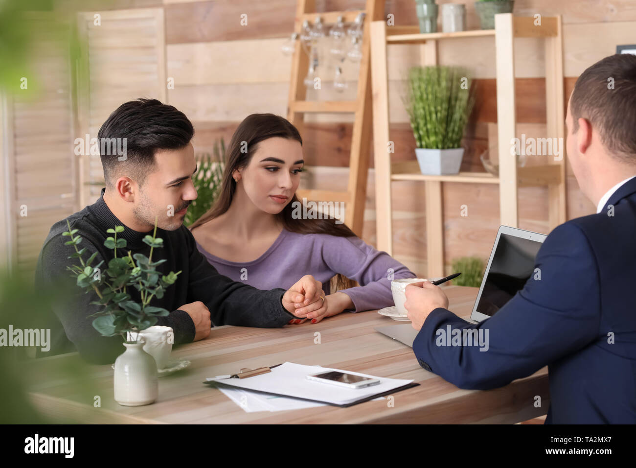 Young couple meeting with insurance agent in cafe Stock Photo - Alamy