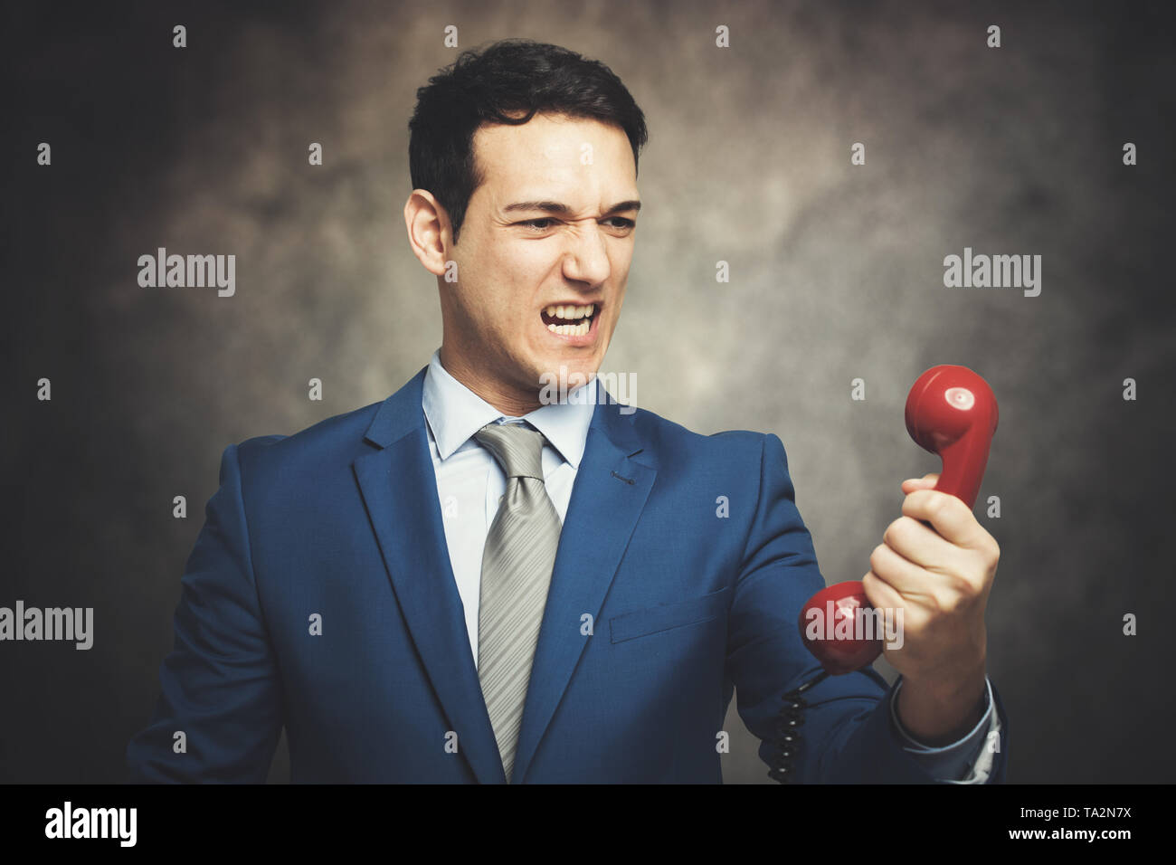 Angry businessman shouting on the phone Stock Photo - Alamy
