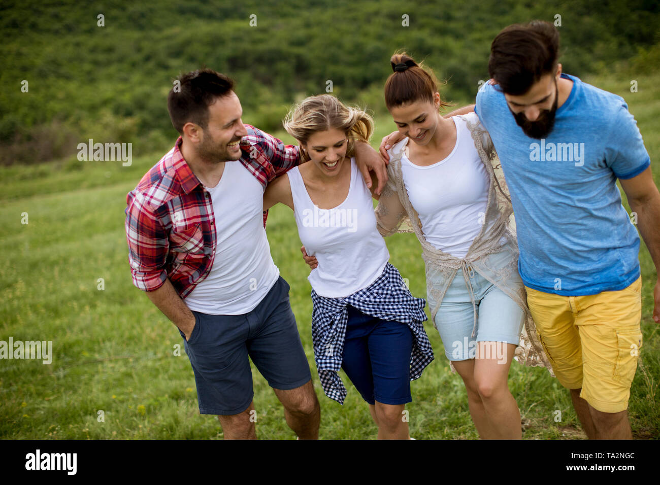 Group of happy young people walking in the summer field Stock Photo - Alamy
