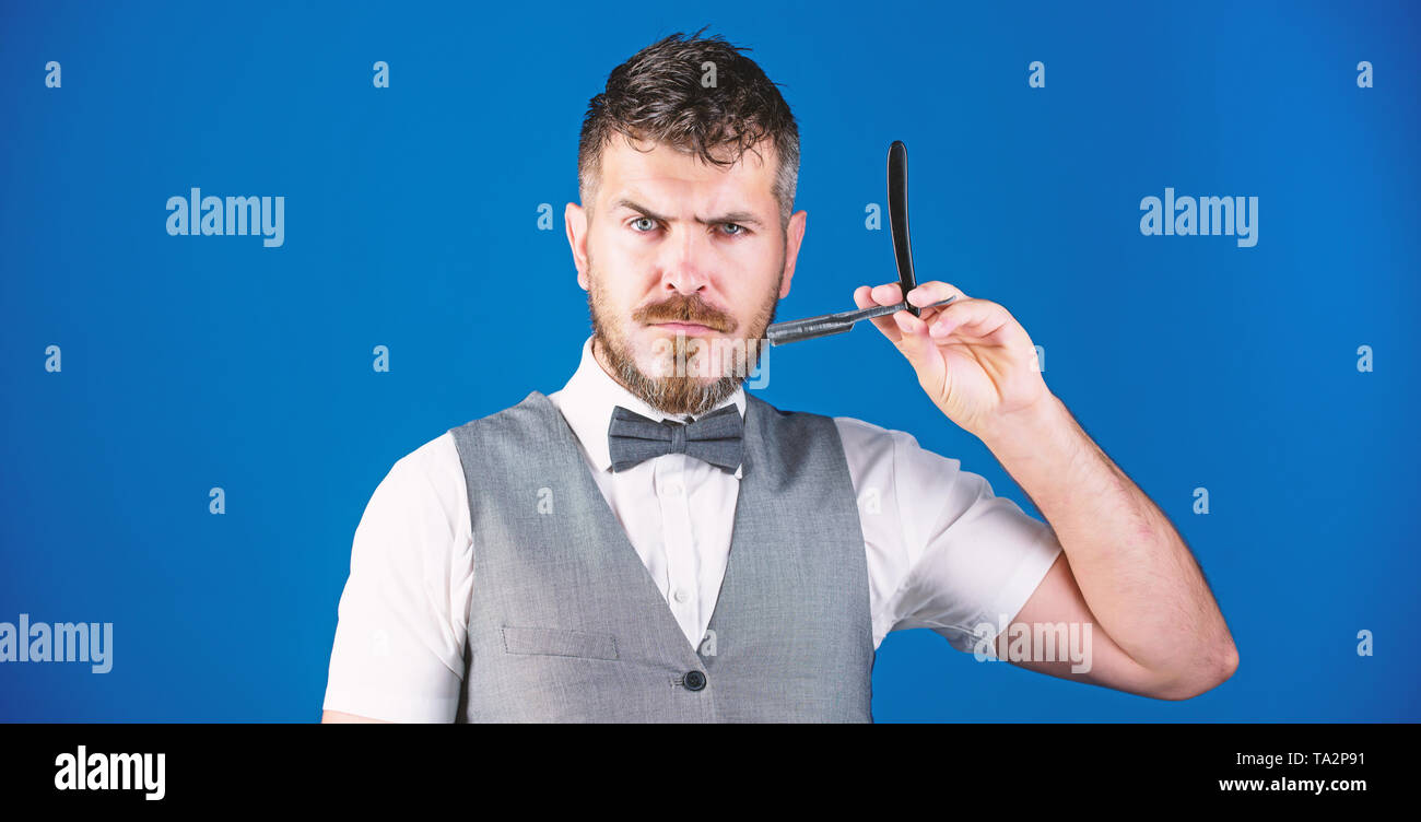 Sharp razor. Bearded man with straight razor in barbershop. Brutal man ...