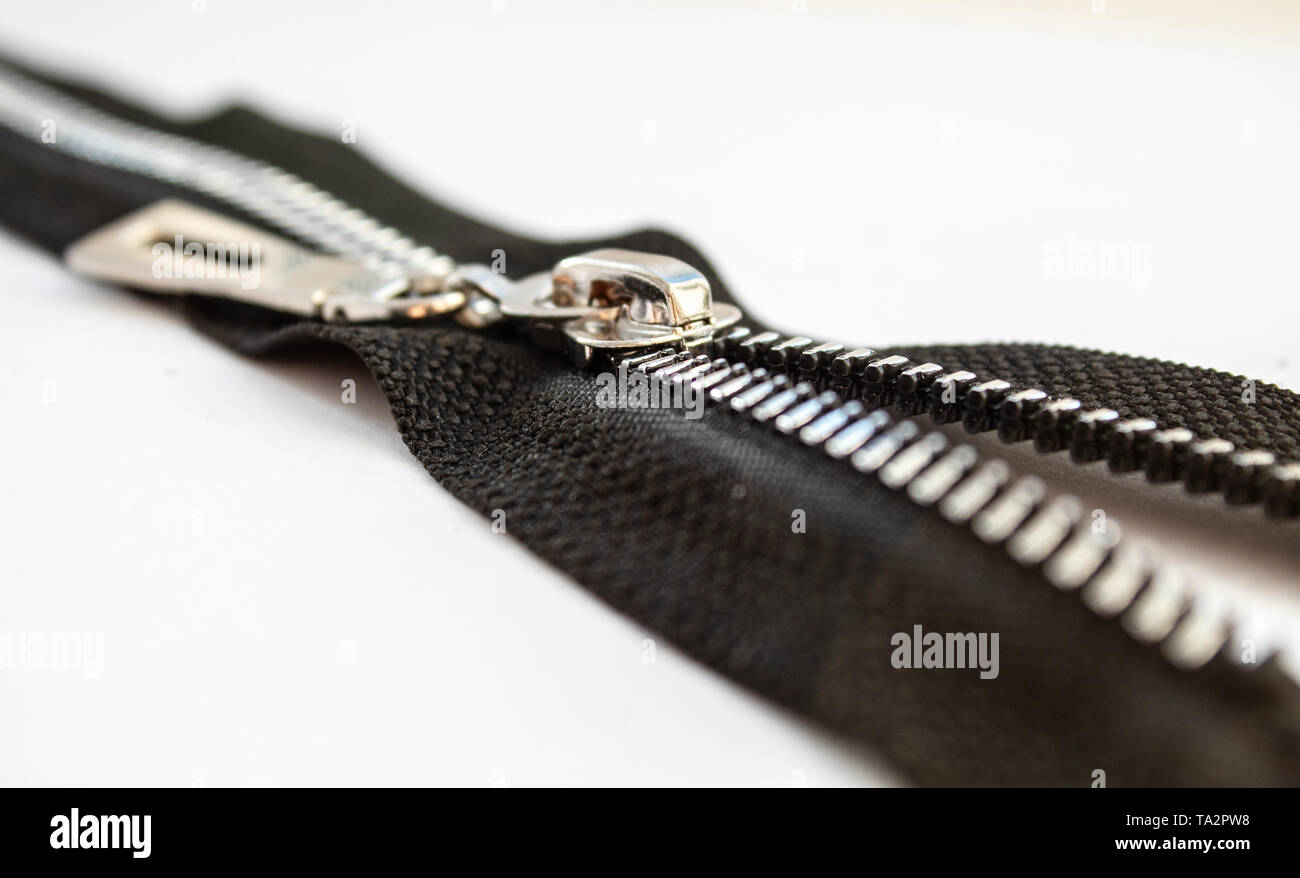 black metal open zipper closeup isolated on white background macro ...