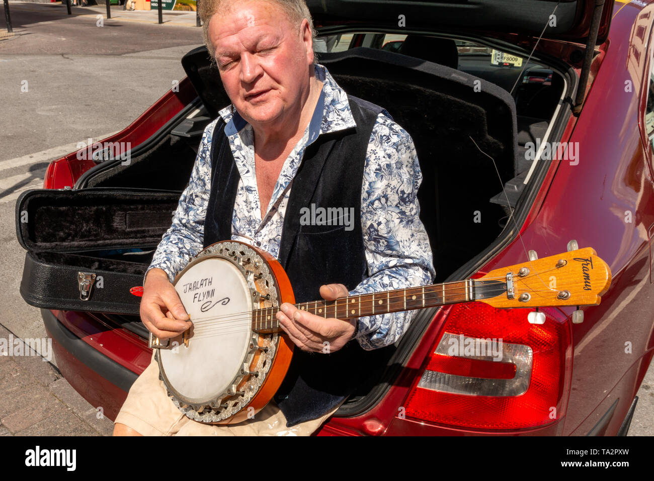 Portrait of Jarlath Flynn - the local flamboyant taxi driver sitting in ...