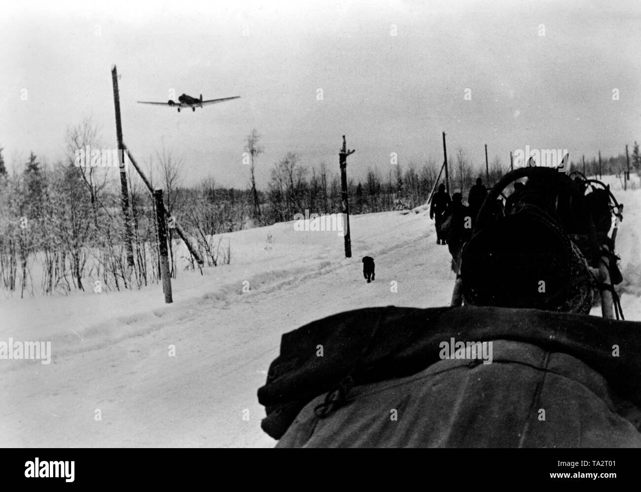 A Junkers Ju 52 crosses a German column near Demjansk. The photo was ...