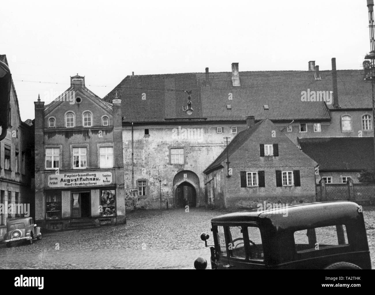 Entrance to the old castle in Labiau in East Prussia, stationery shop ...