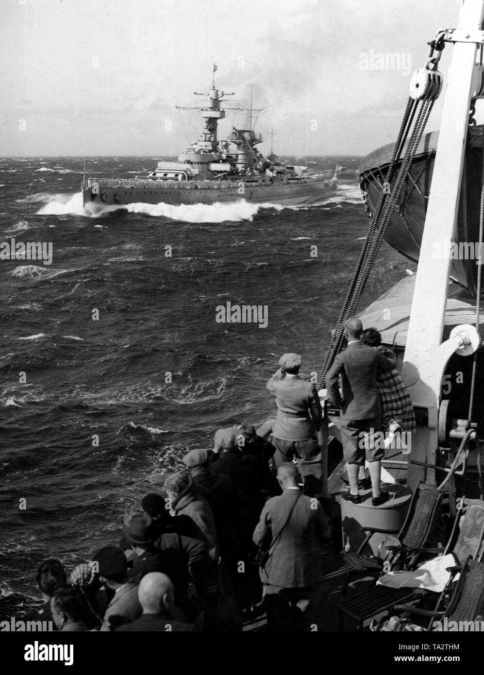 The Panzerschiff "Deutschland" of the German Kriegsmarine passes the fleet of the Nazi ...