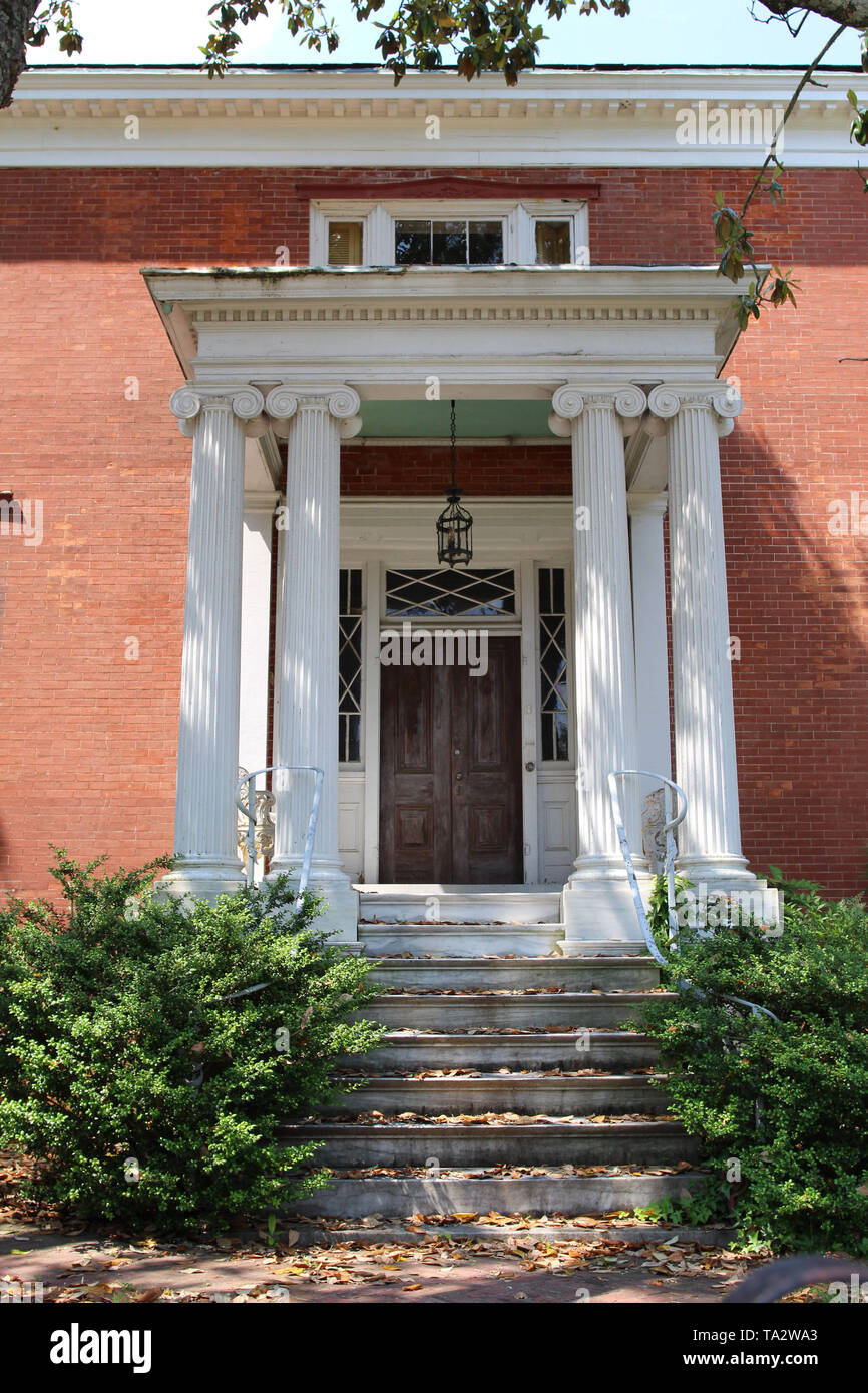A front porch of the southern colonial building, including symmetrical ...
