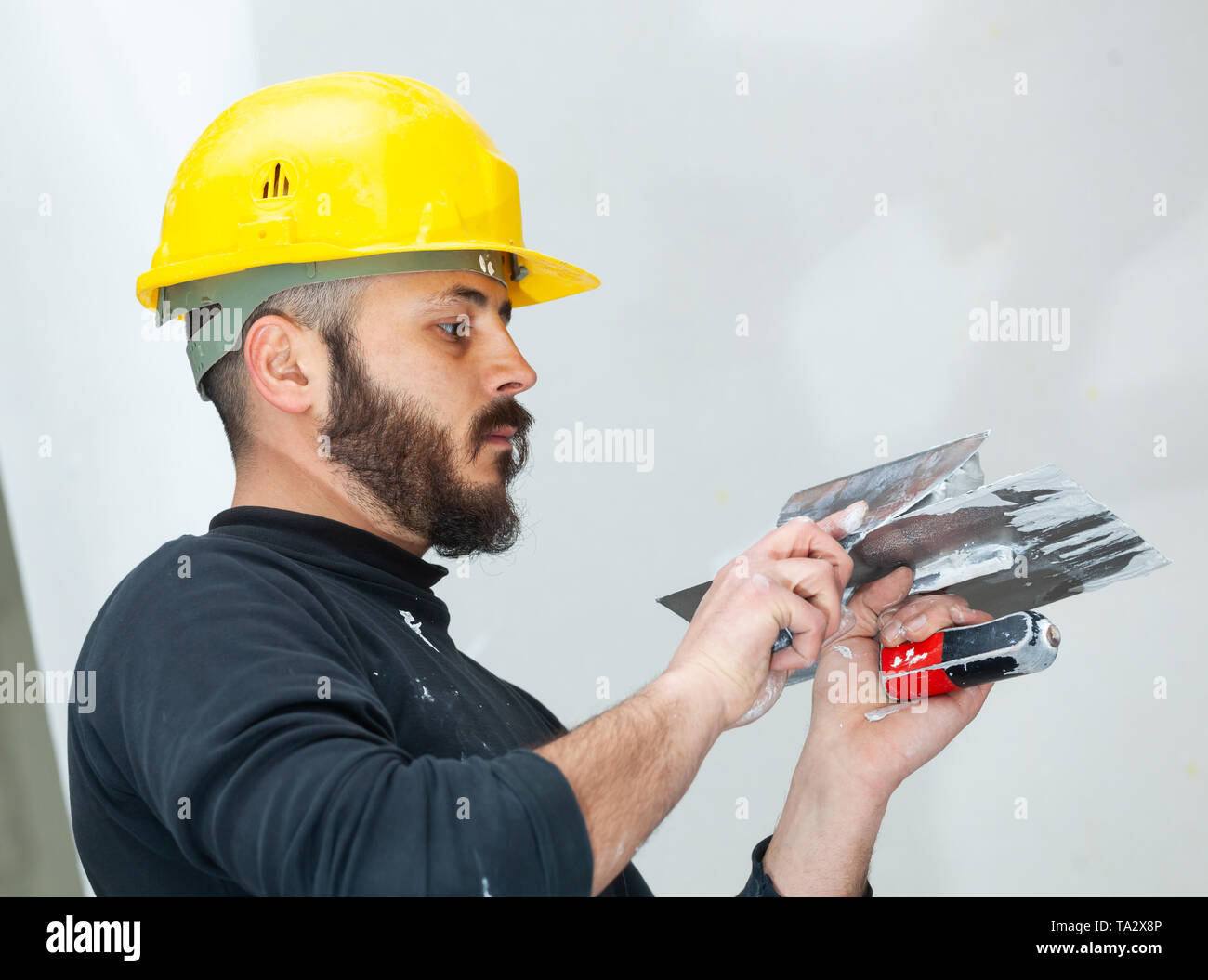 Interior construction, worker plastering gypsum board wall Stock Photo ...